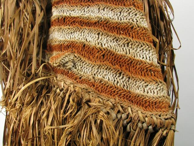 A FINE ASMAT DANCE COSTUME (jipaee), of woven fibre with grass tassels ador
