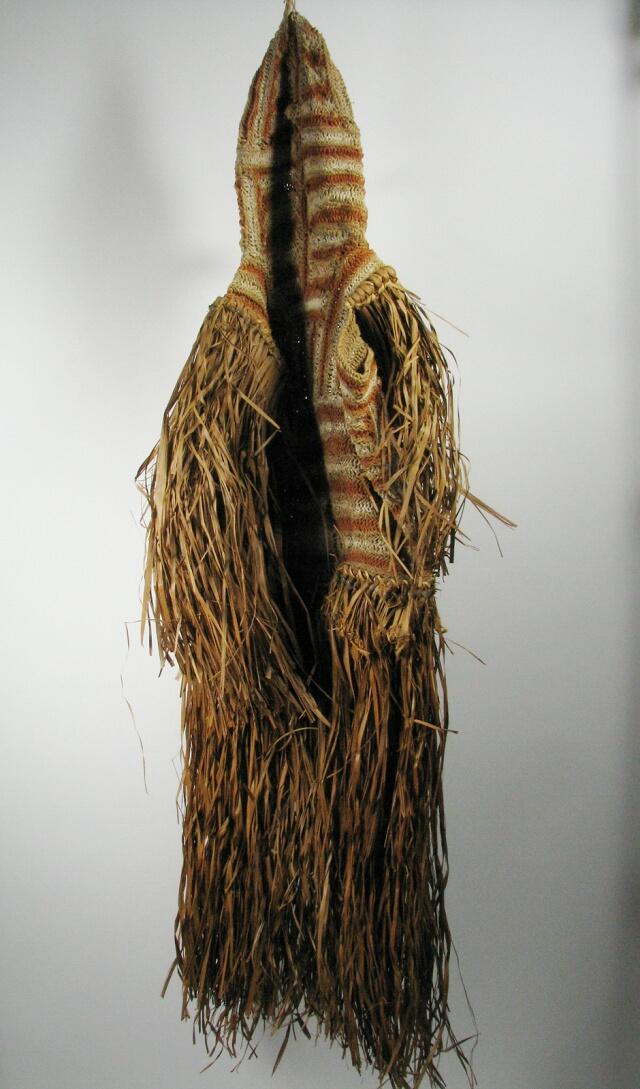 A FINE ASMAT DANCE COSTUME (jipaee), of woven fibre with grass tassels ador