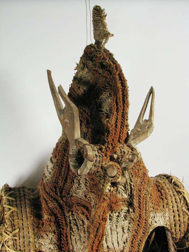 A FINE ASMAT DANCE COSTUME (jipaee), of woven cane and fibre with grass tas