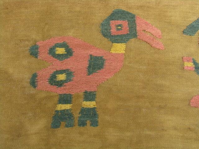 A PRE-COLUMBIAN TEXTILE FRAGMENT, Paracas Culture, of woven cotton embroide