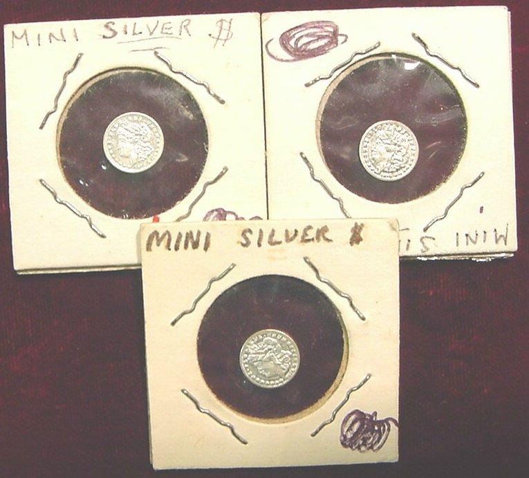 (3) Miniature Silver Morgan Dollars.