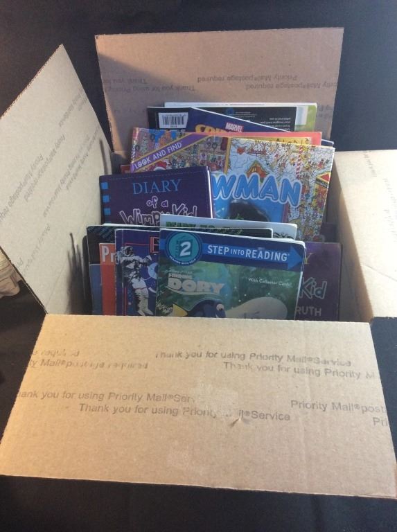 Large box of miscellaneous kids books may contain writing or stickers