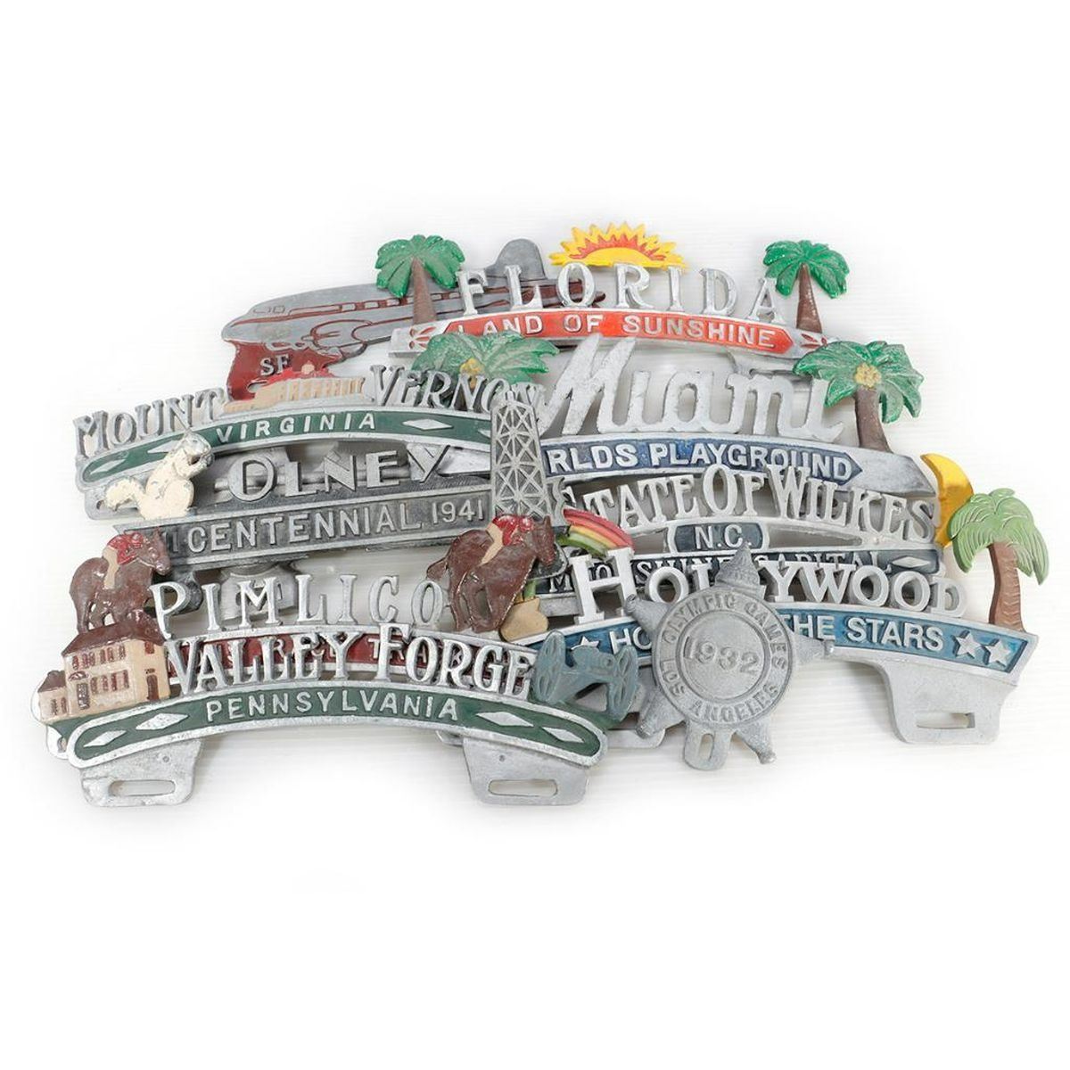 Ten Cast Aluminum License Plate Toppers and a 1932 Olympics Medallion