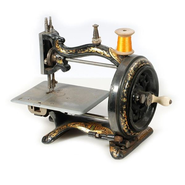 Antique manual sewing machine. Lion HR trademark. Lion is carrying flag ...