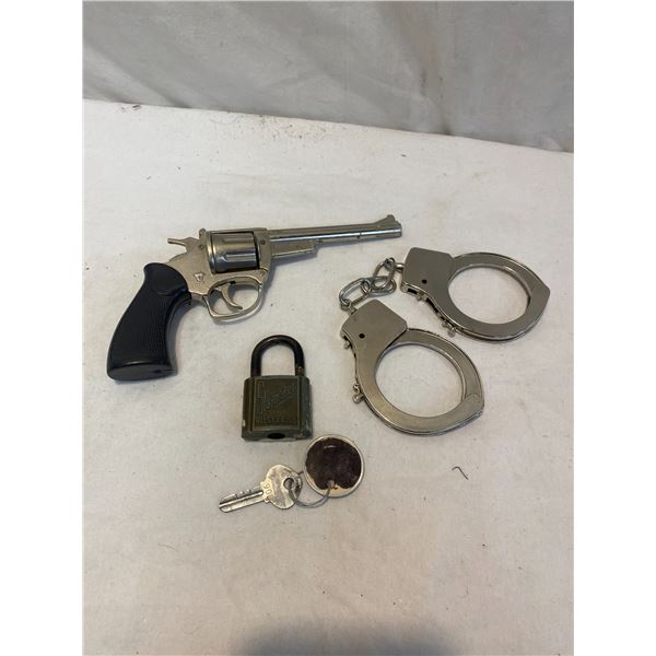Cap gun, hand cuffs and key with lock