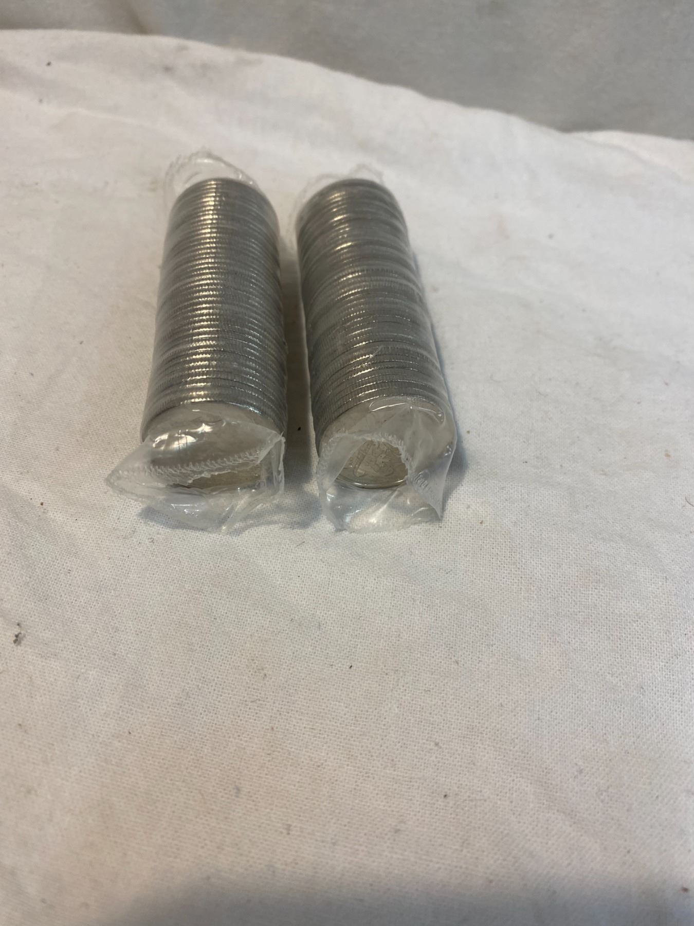 Two rolls of Canadian quarters uncirculated