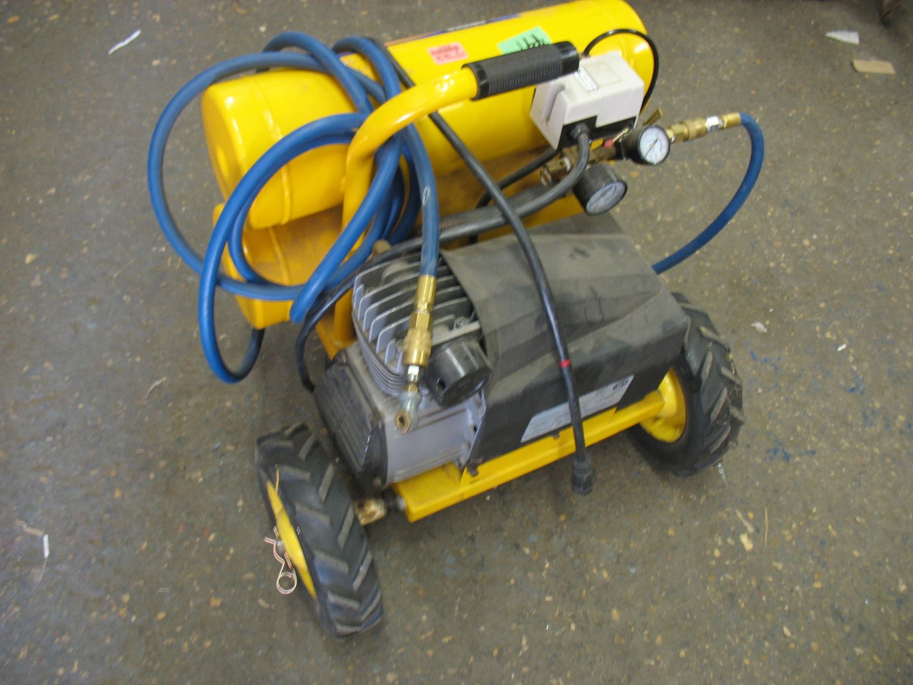 Power fist 2 horsepower oilless air compressor has had wheels added to it