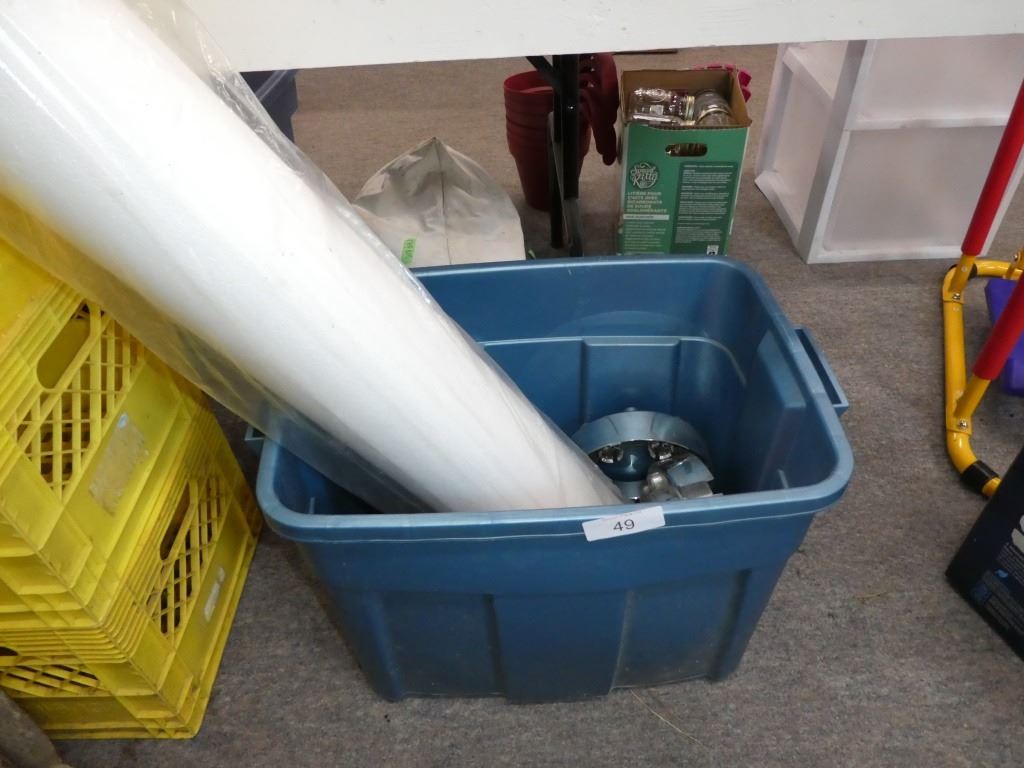 Ford hub caps, roll of plastic, plastic tote, cord