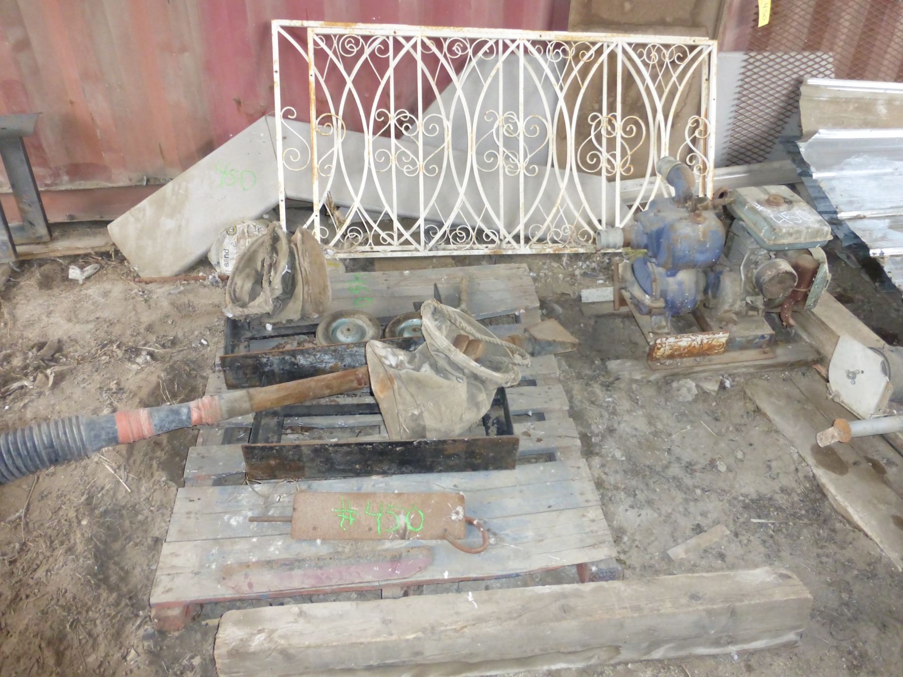 White railing, metal, wheels, expanded metal, old water pump