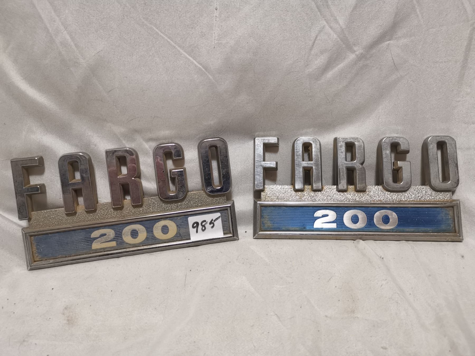 Pair of Fargo 200 metal emblems - Schmalz Auctions
