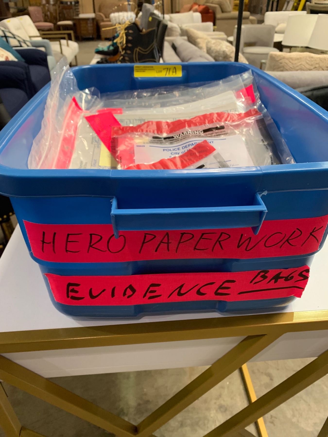 Bin of Hero paperwork and evidence bags from movie