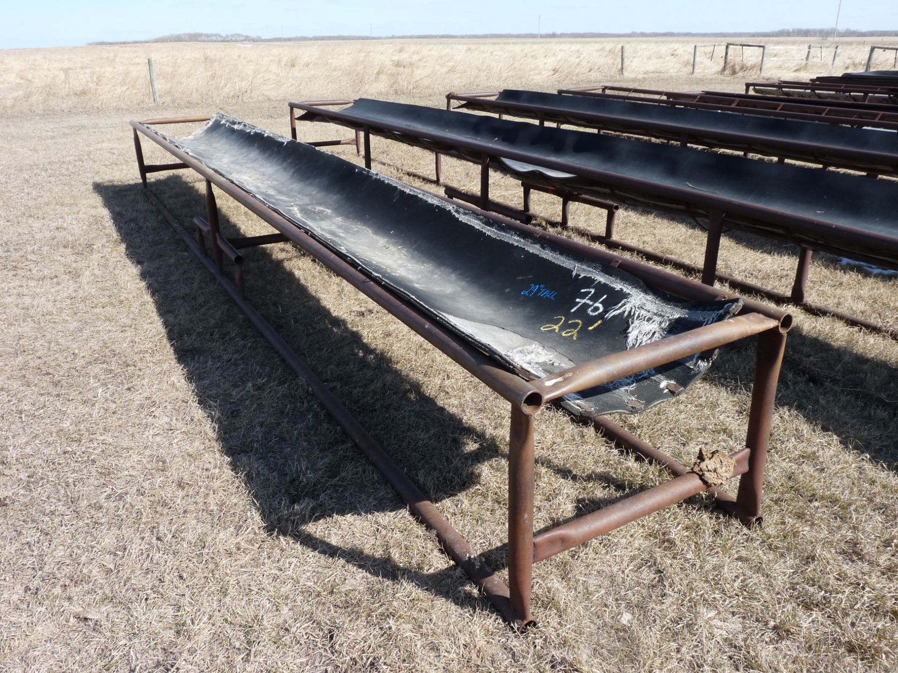 Heavy duty feed trough lined with belting