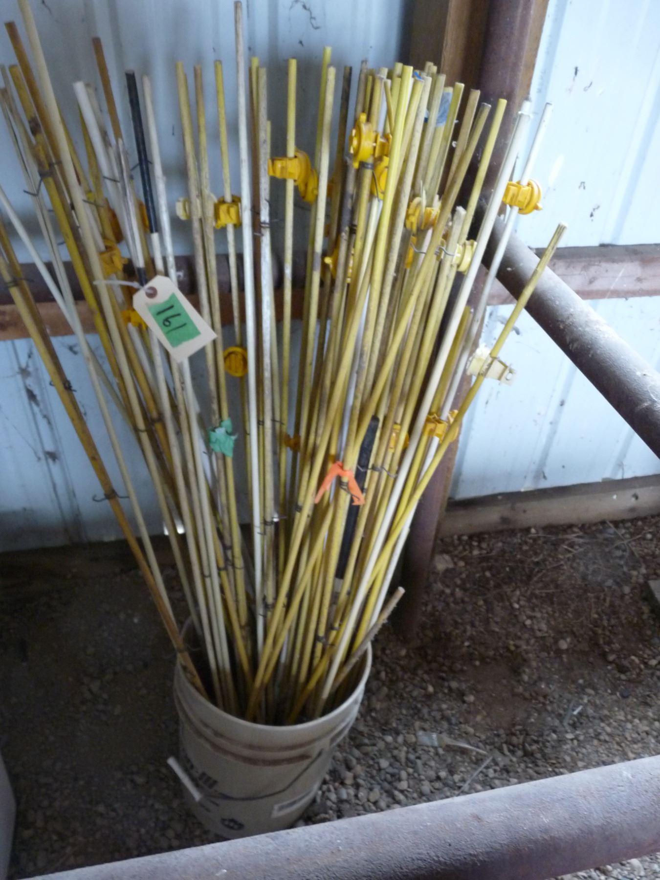 pail of fiberglass electric fence posts