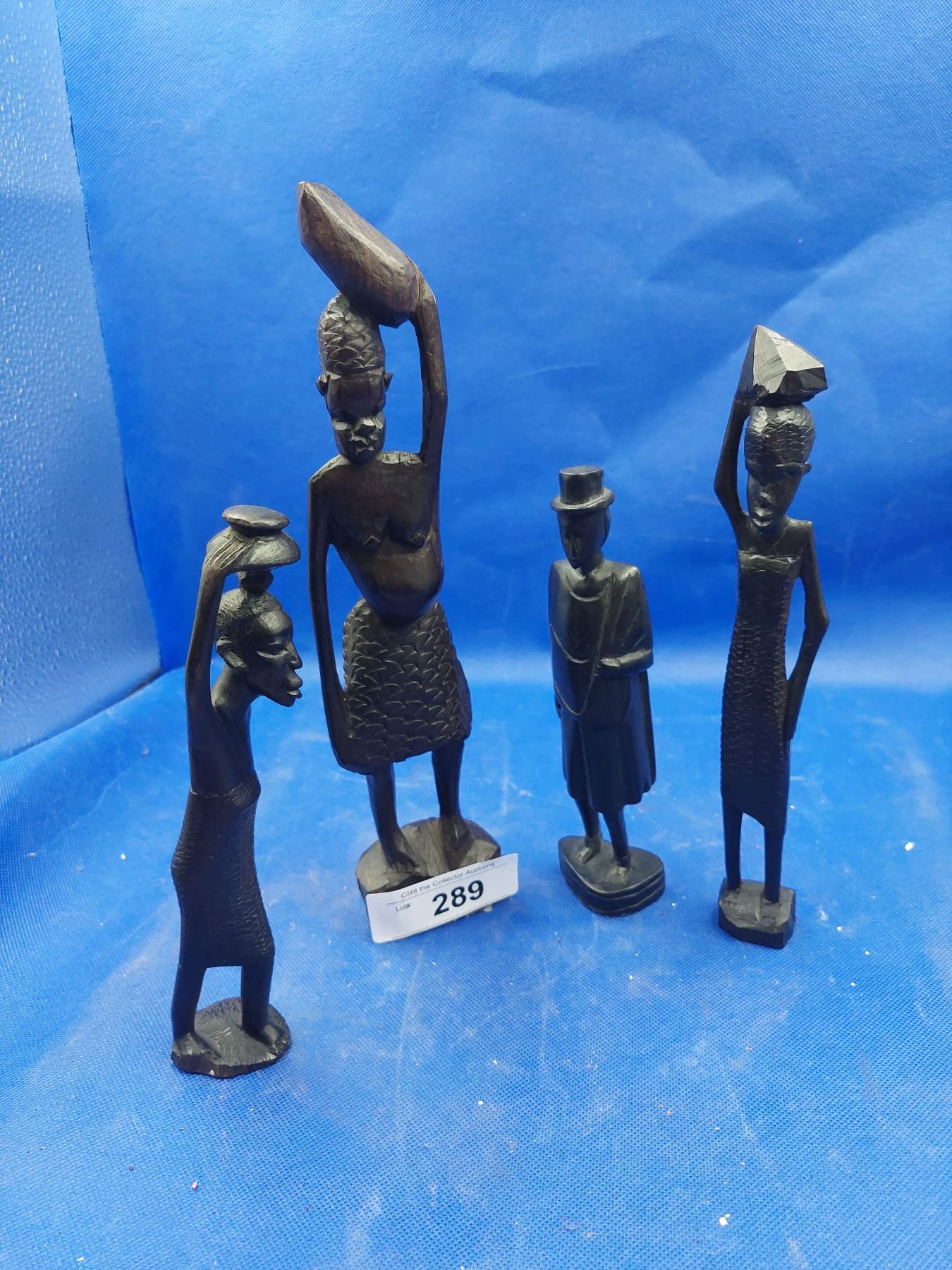 FOUR AFRICAN HAND CARVED WOOD STATUES