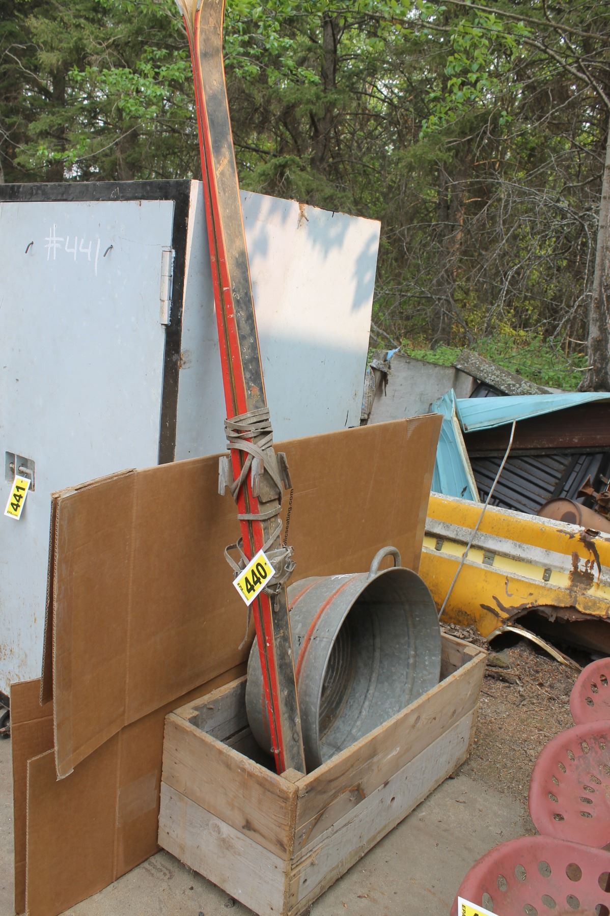 Wood box, metal tub and skis.