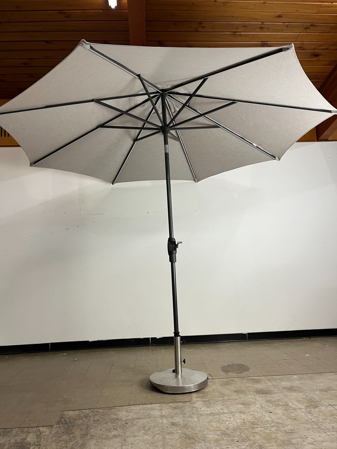 Adjustable outdoor umbrella. Very heavy base. Approximately 8 feet tall ...