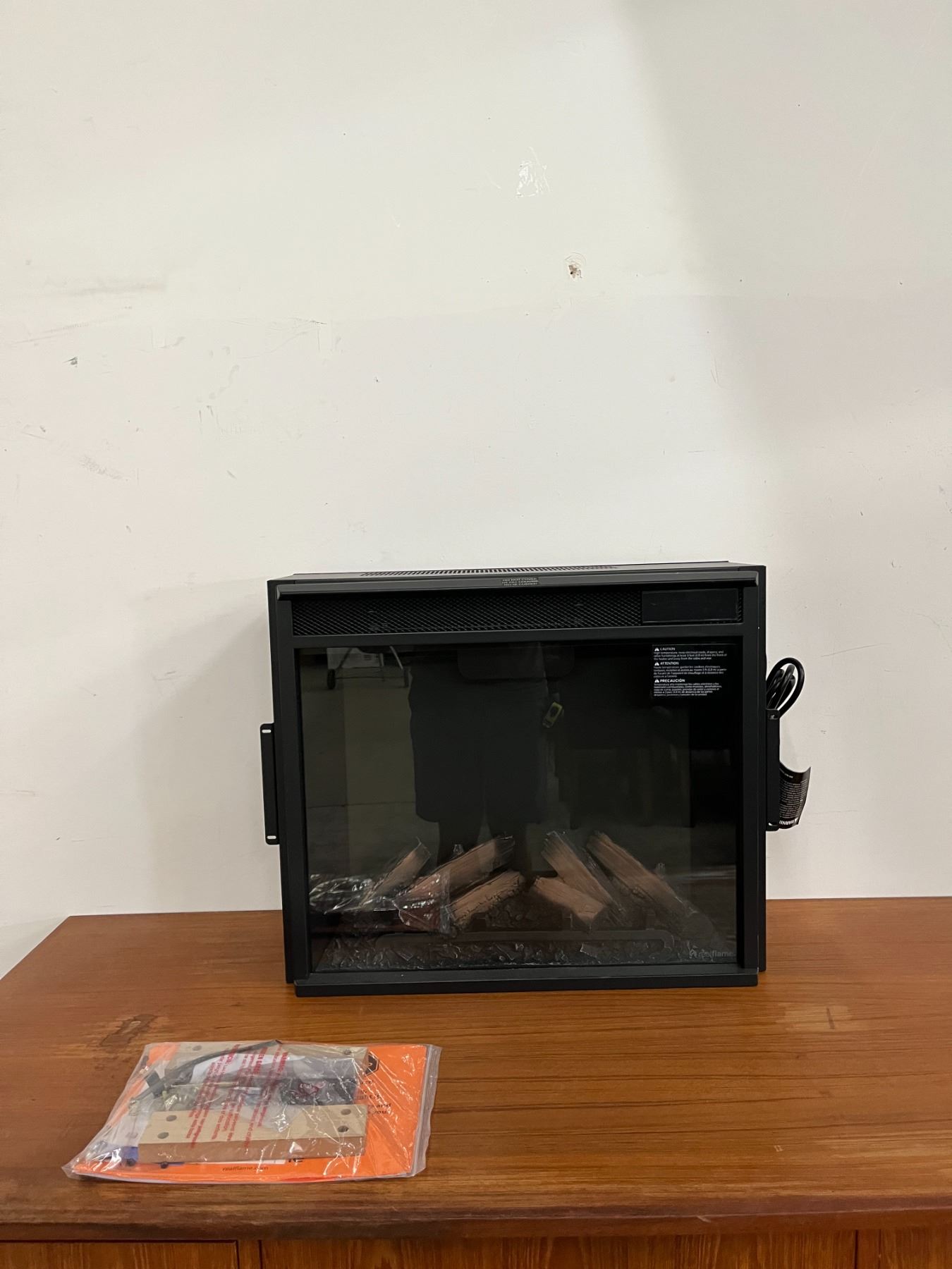 Realflame electric fireplace model 4199 with remote. Appears unused.