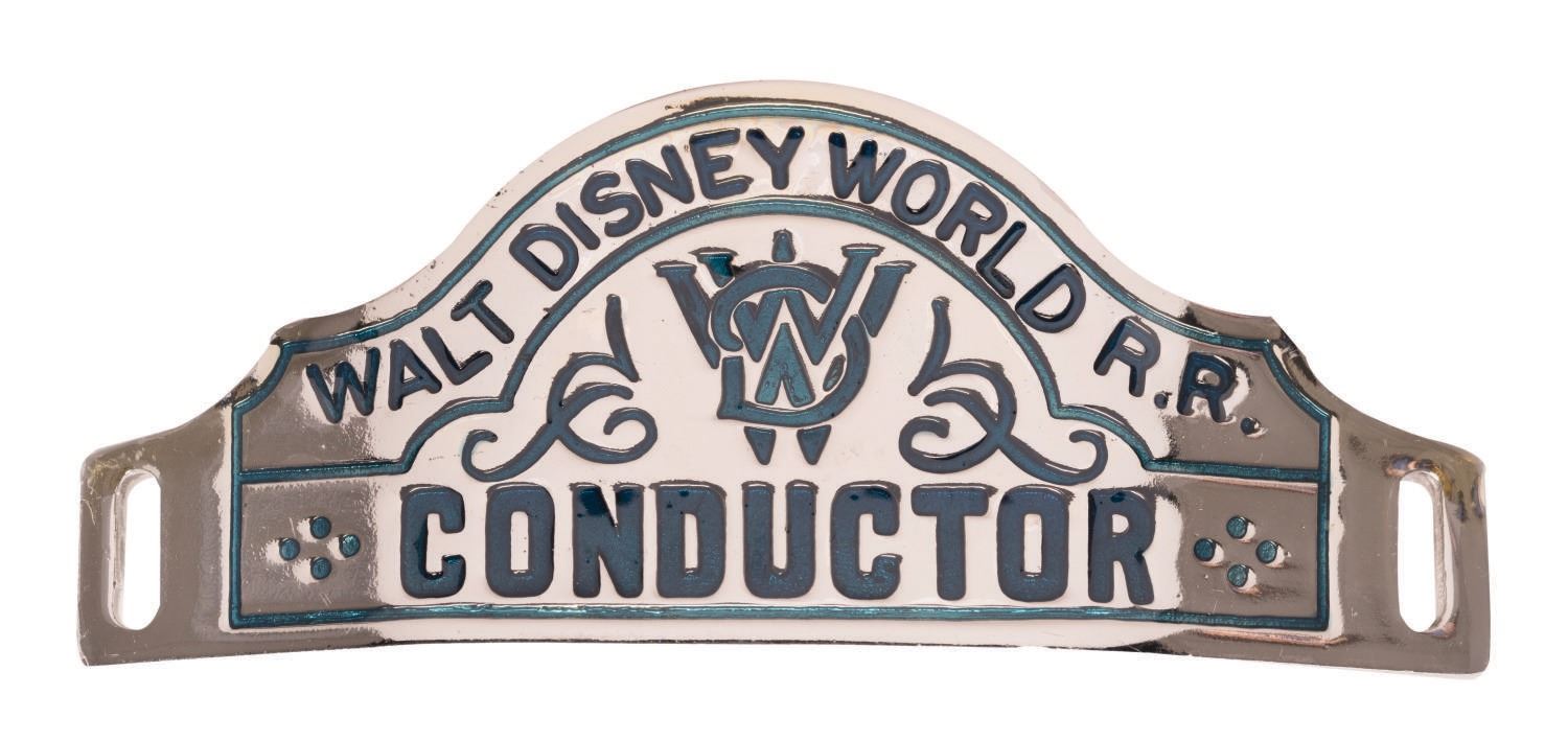 A Walt Disney World Railroad Conductor Hat Badge. - Van Eaton Galleries
