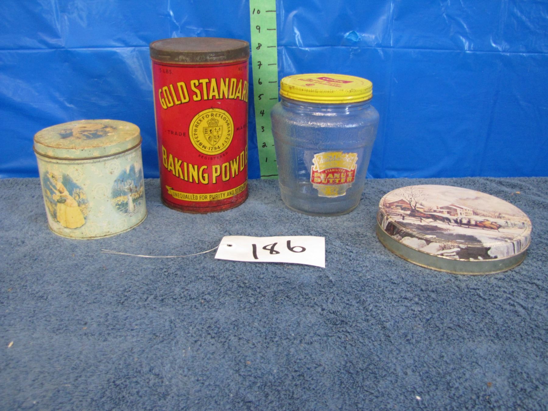 Vintage gold standard baking powder tin, peanut butter glass jar, and tins