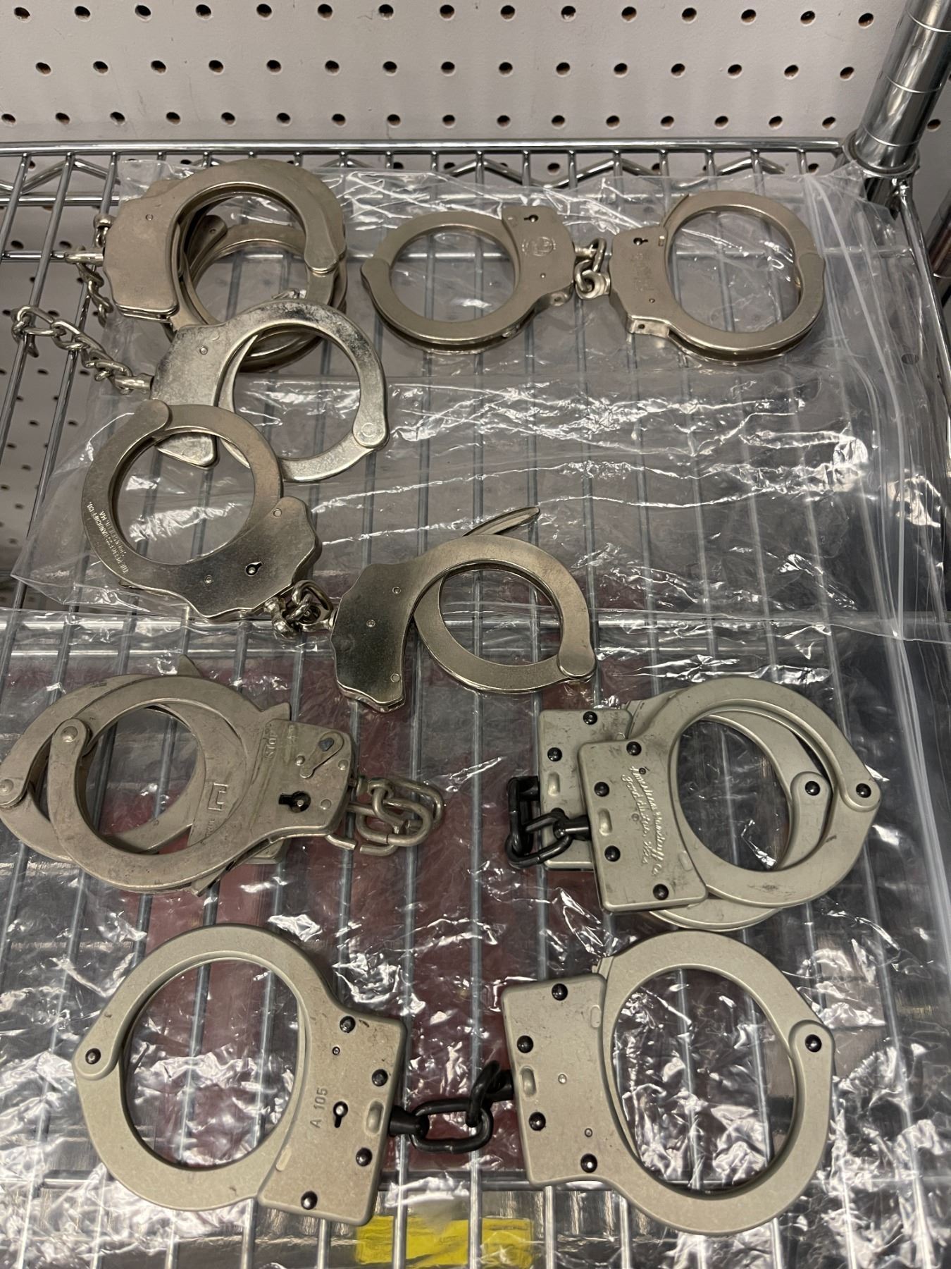 Group of 7 assorted metal handcuffs (1 needs chain repair)