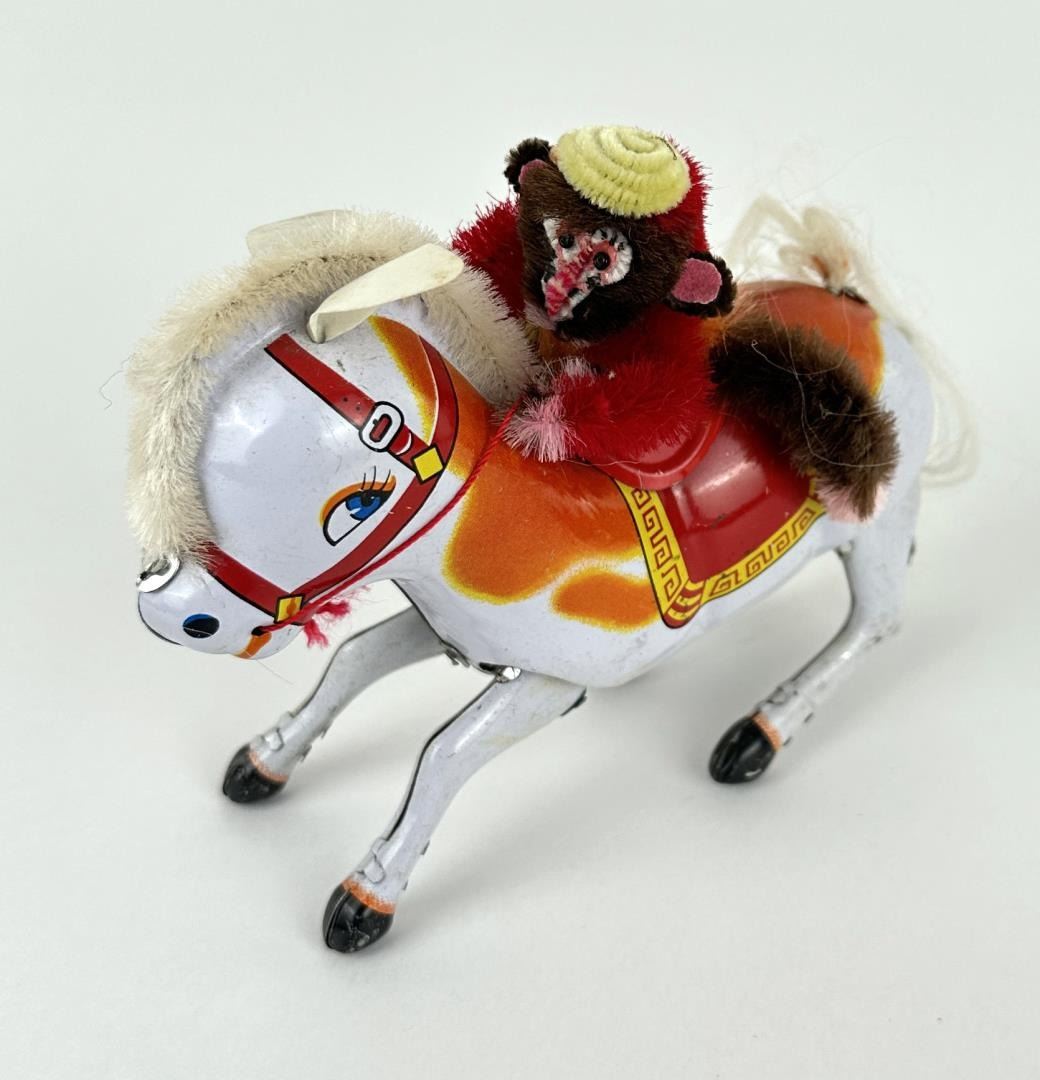 Monkey Riding Horse Tin Toy