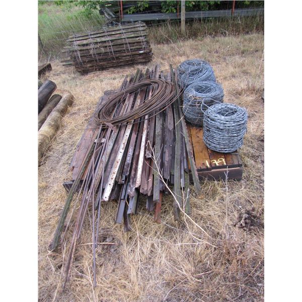 Skid with four rolls of barbed wire and steel fence posts