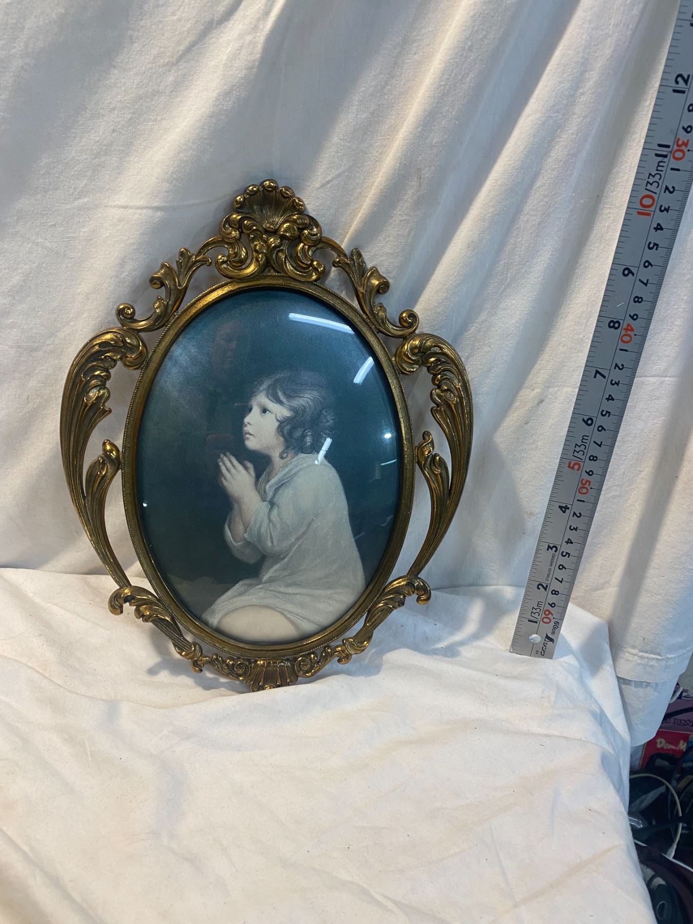 Ornate brass frame, infant Samuel in prayer