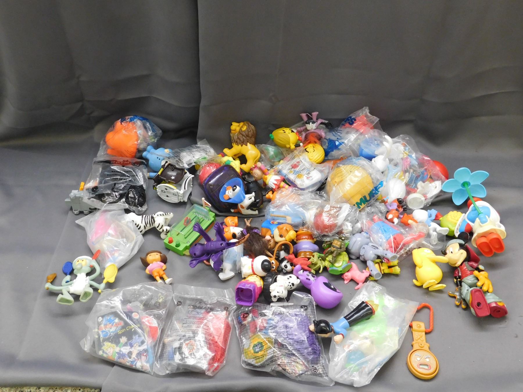Lot of Assorted McDonalds Fast Food Premiums Beyblade, Pokemon, Smurfs, Etc