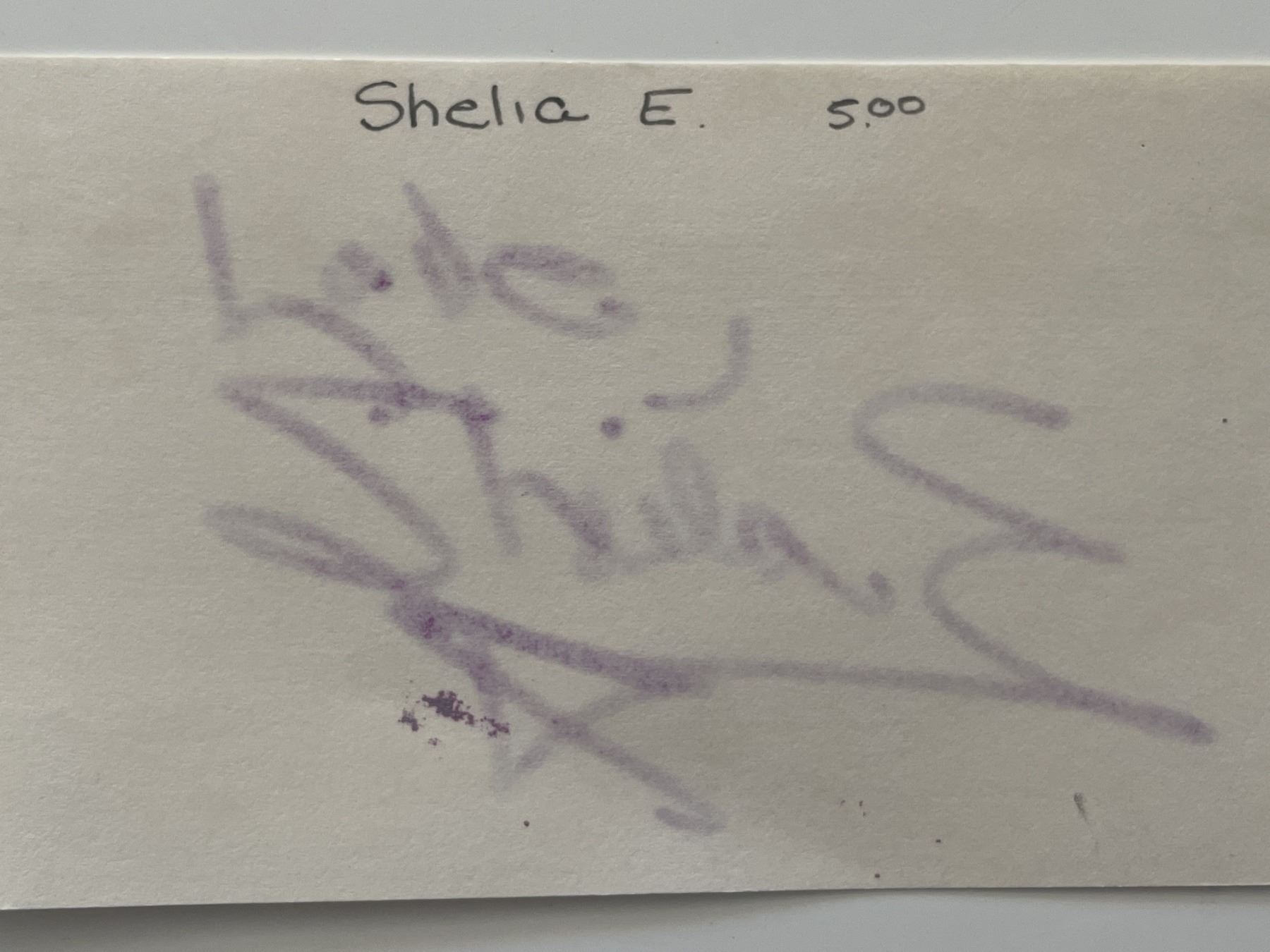 Sheila E. signed note. 3x5 inches