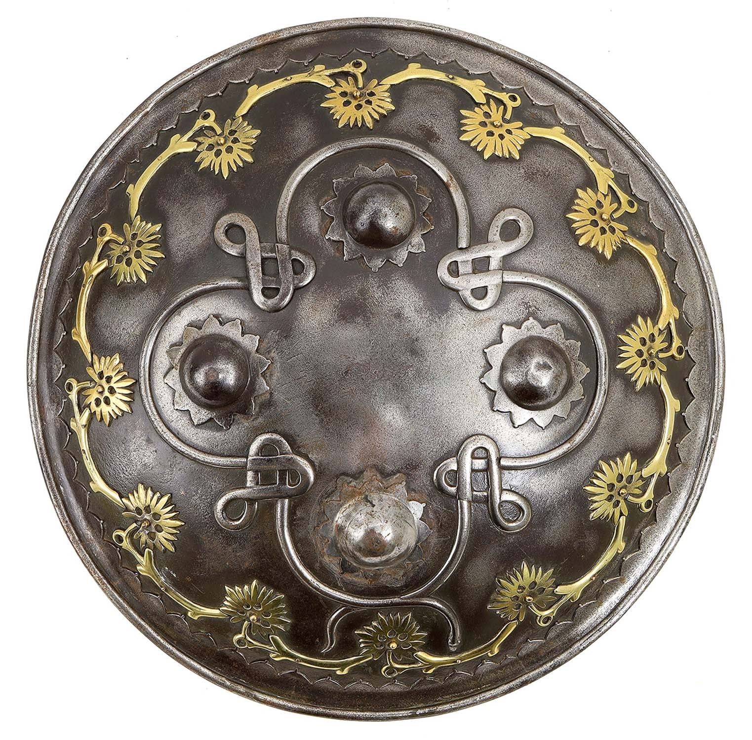 AN INDIAN CEREMONIAL SHIELD WITH BRASS AND STEEL OVERLAY