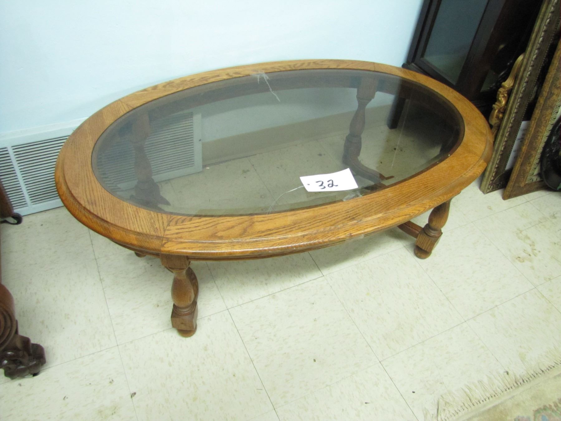 Wood framed oval coffee table with bevelled edge glass top ...