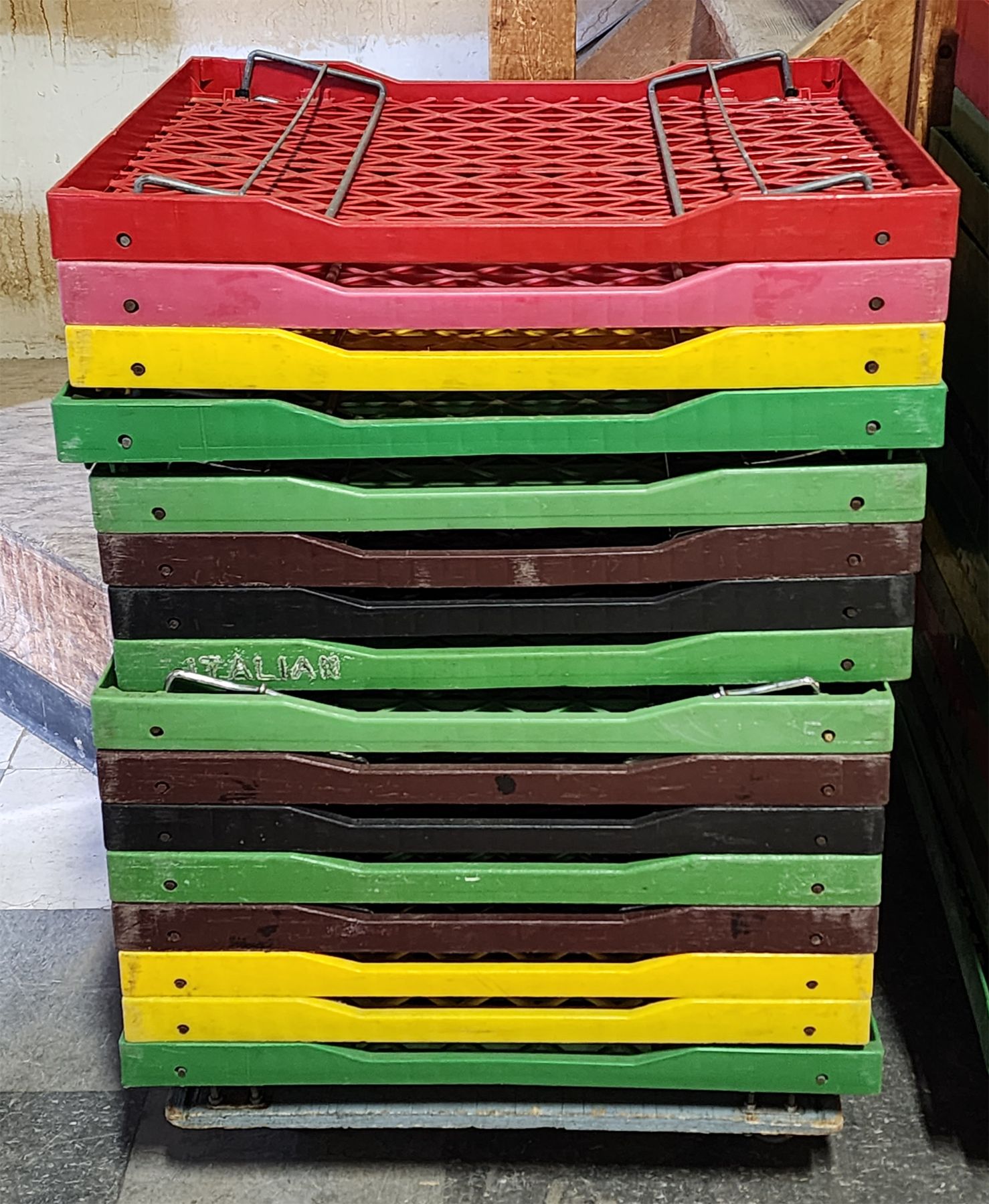 STACK OF BREAD TRAYS WITH ROLLING DOLLY