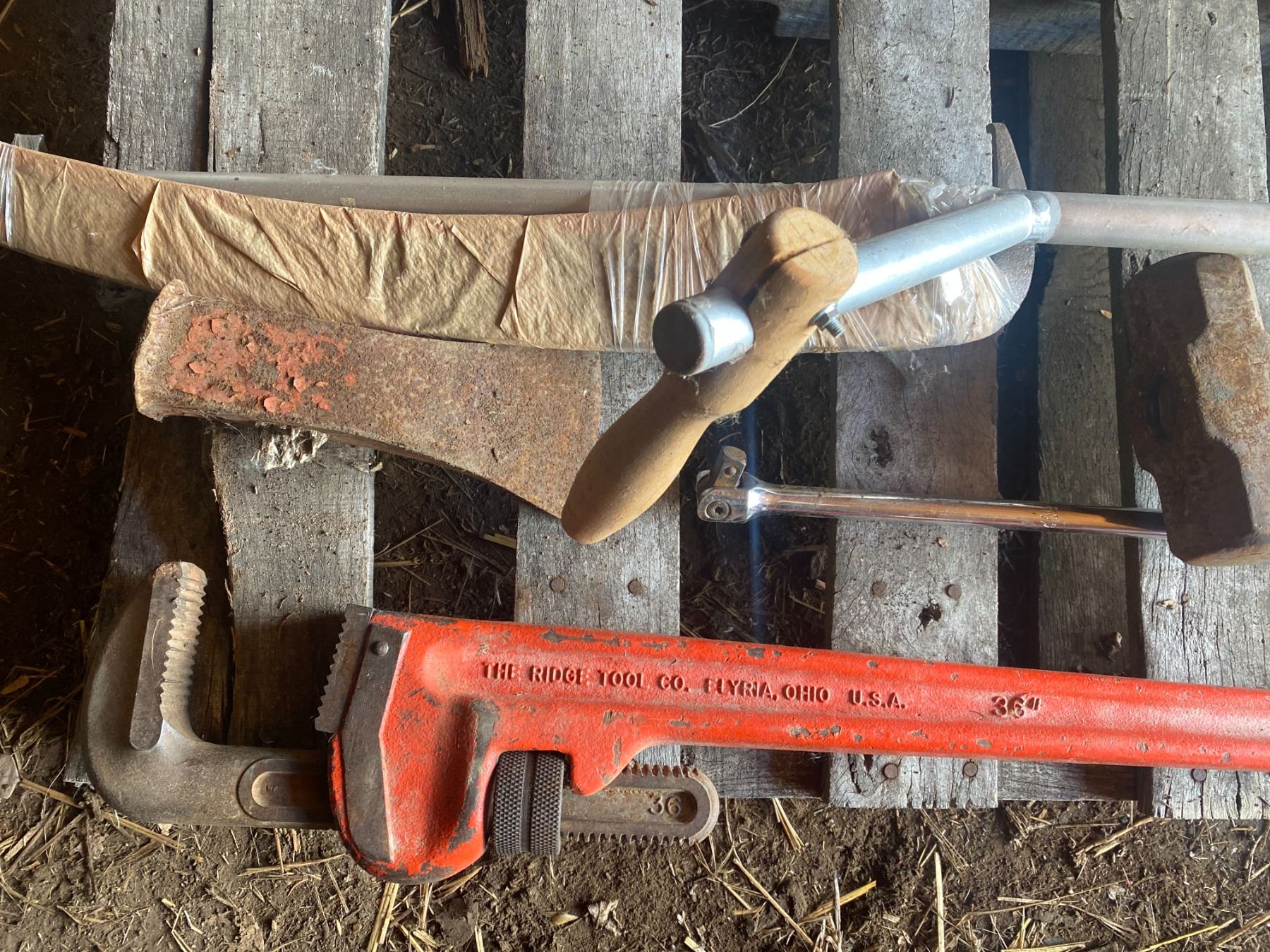 4- Crescents, flex bar, pipe wrench, new sythe, sledge hammer]