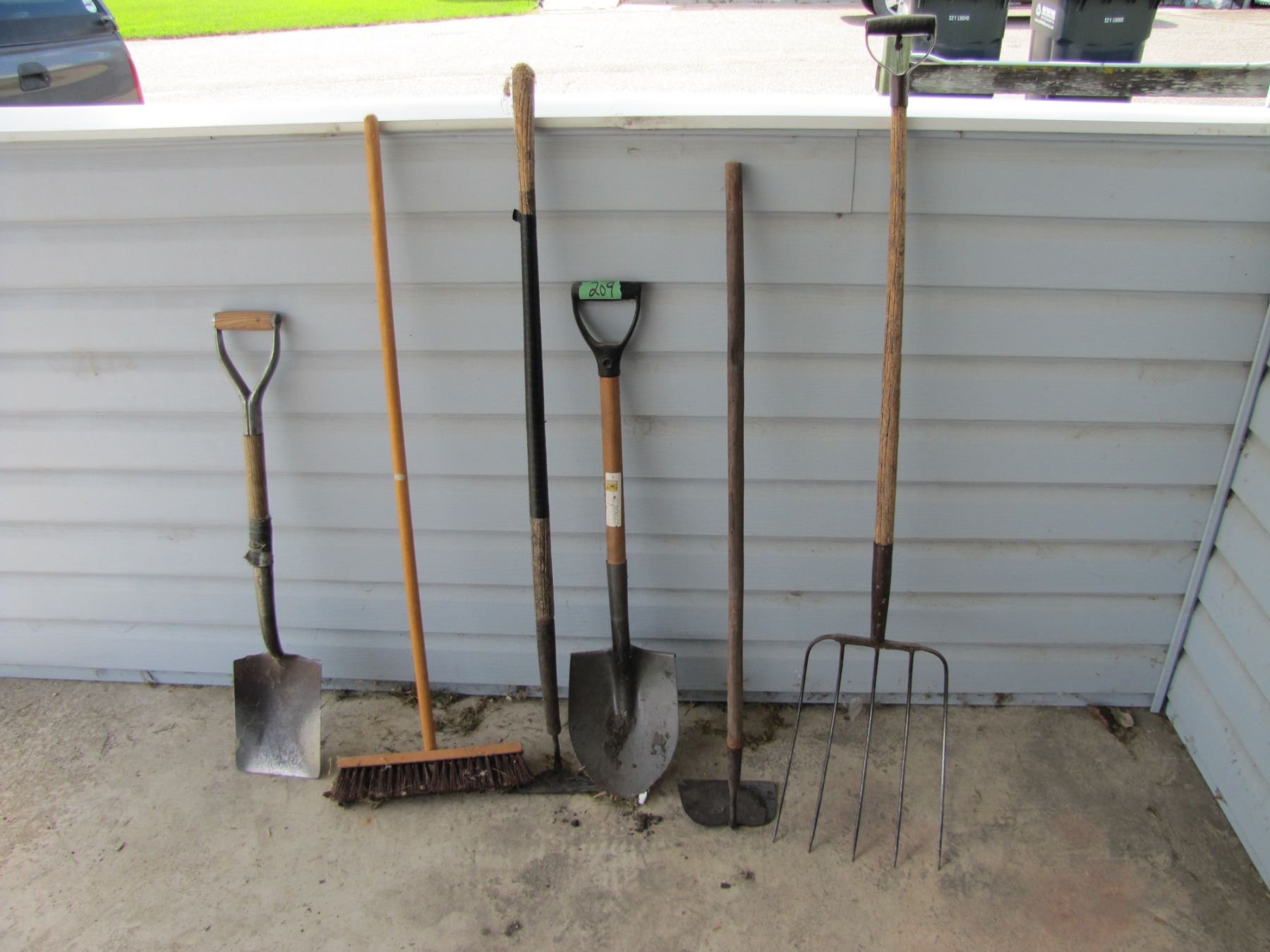 Lot of yard hand tools , shovels, hoes, push broom, fork
