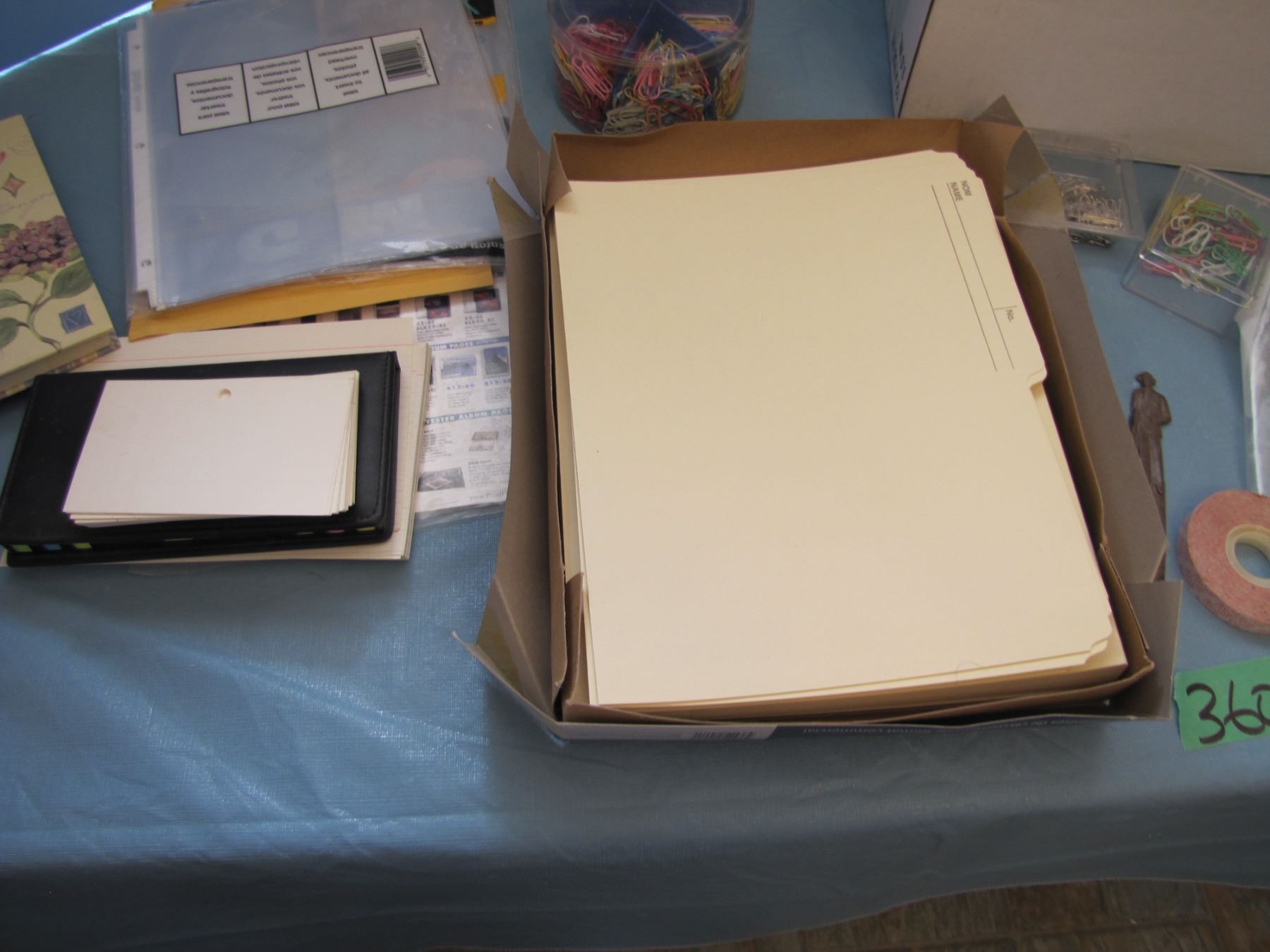 Hole punch, file folders, pens, Various office supplies