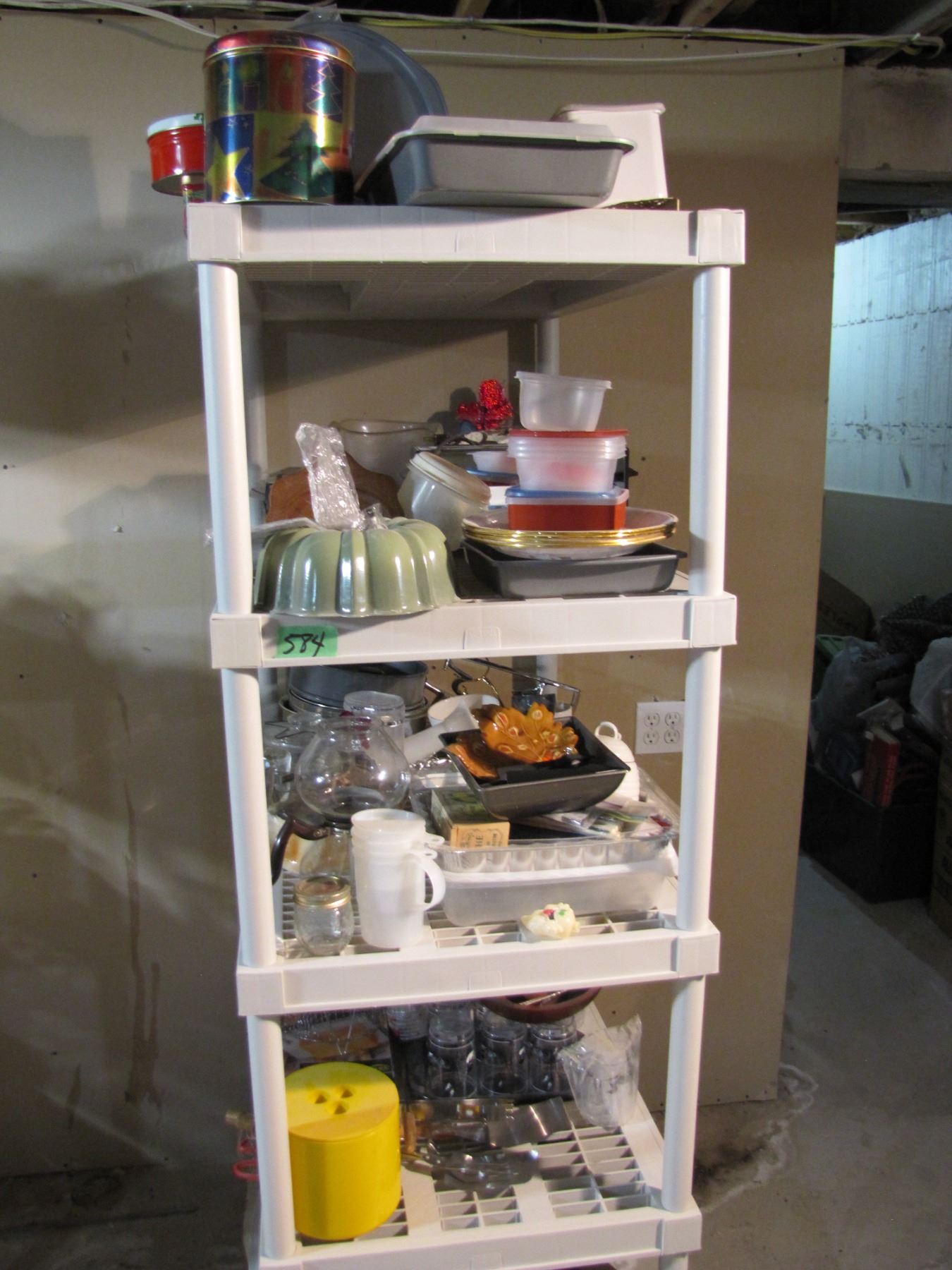 Shelving unit and contents , empty tins, baking pans, coffee pot, bag ...