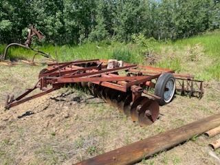 Approx. 12 ft IH Field Disc. Wheels were found & were put on. Loader ...