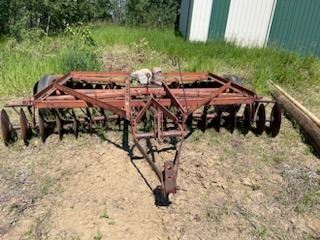 Approx. 12 ft IH Field Disc. Wheels were found & were put on. Loader ...