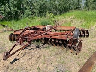 Approx. 12 ft IH Field Disc. Wheels were found & were put on. Loader ...