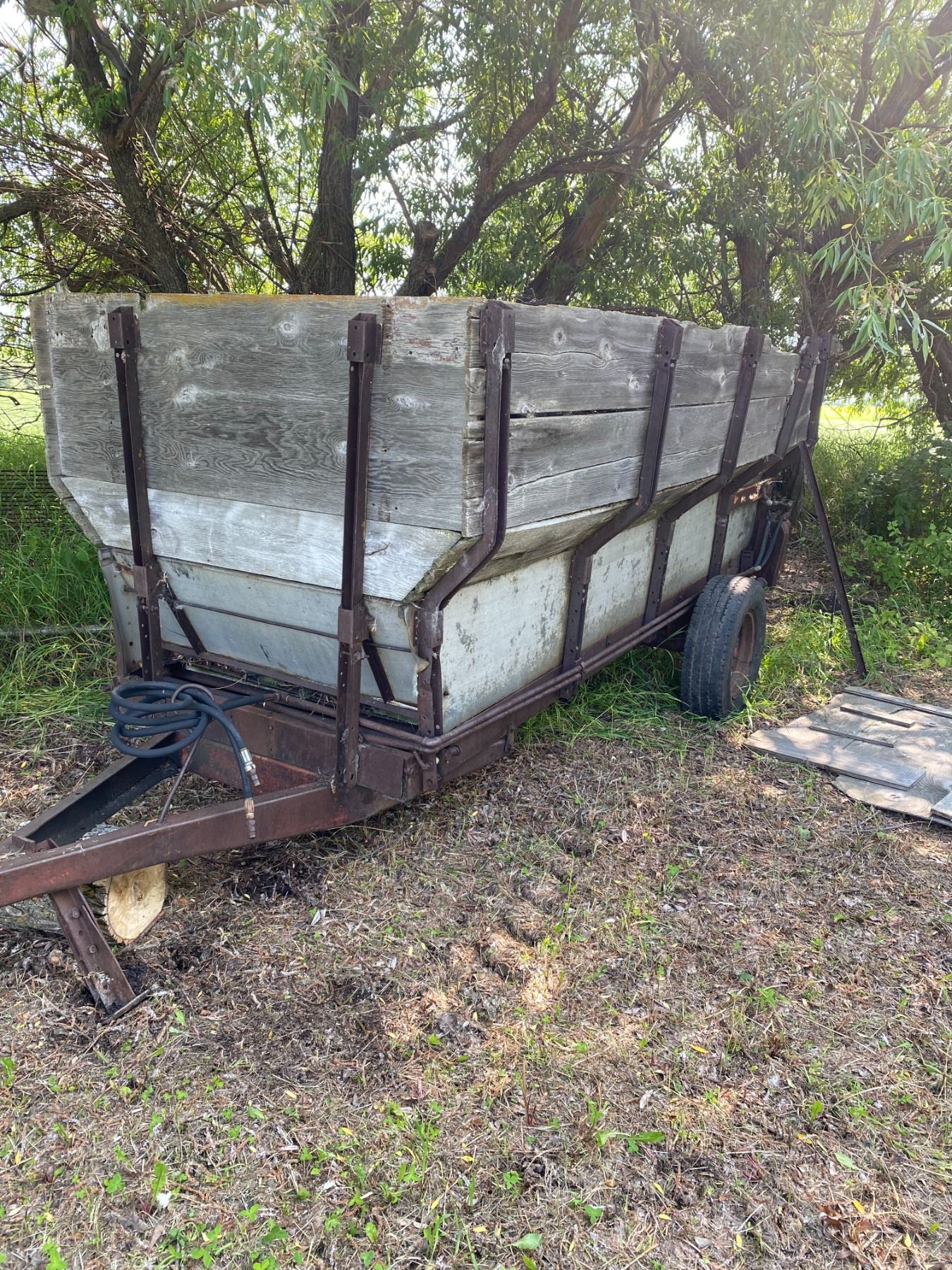 Old converted manure spreader c/w hyd. Drive c/e fence posts & barb wire