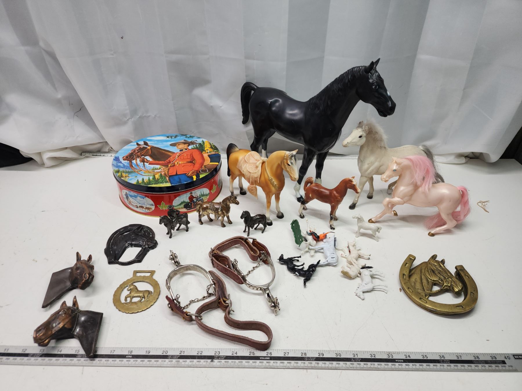 Collection of horse items - brass door knocker, toys, spurs, etc.