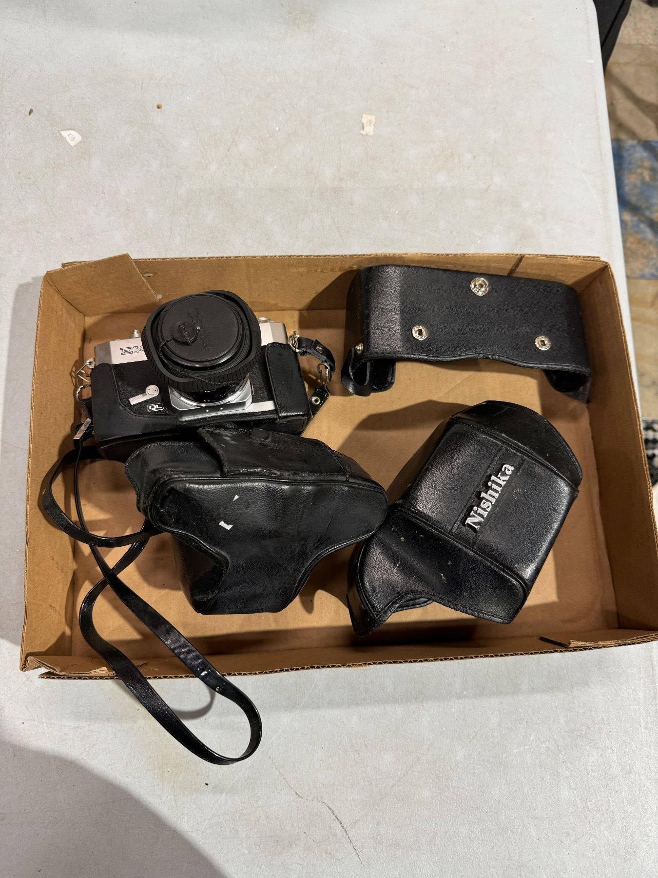 vintage Canon camera with other camera case