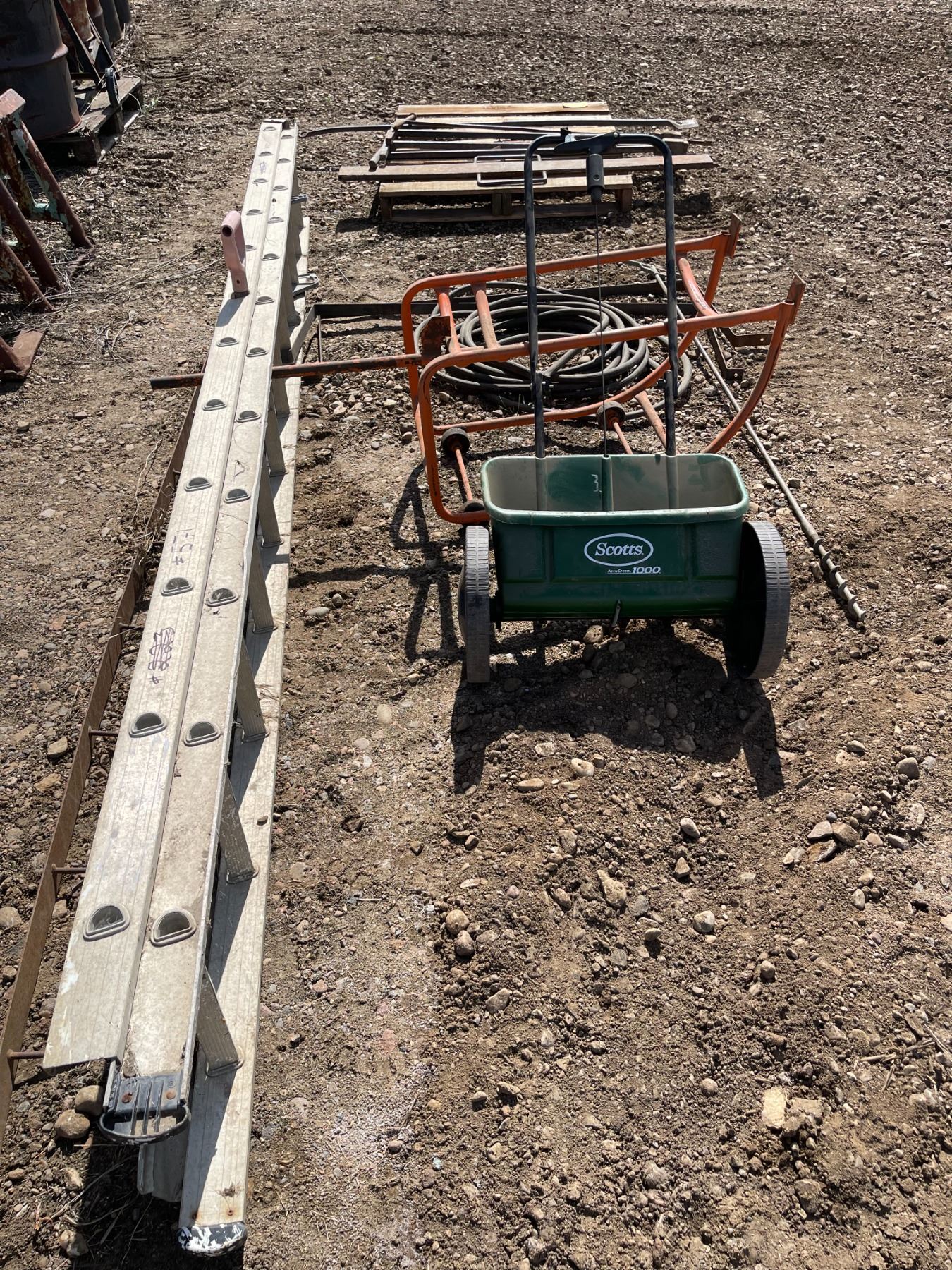 Ladder, Fertilizer/Seed spreader, hose, strapping, oil barrel dolly and ...