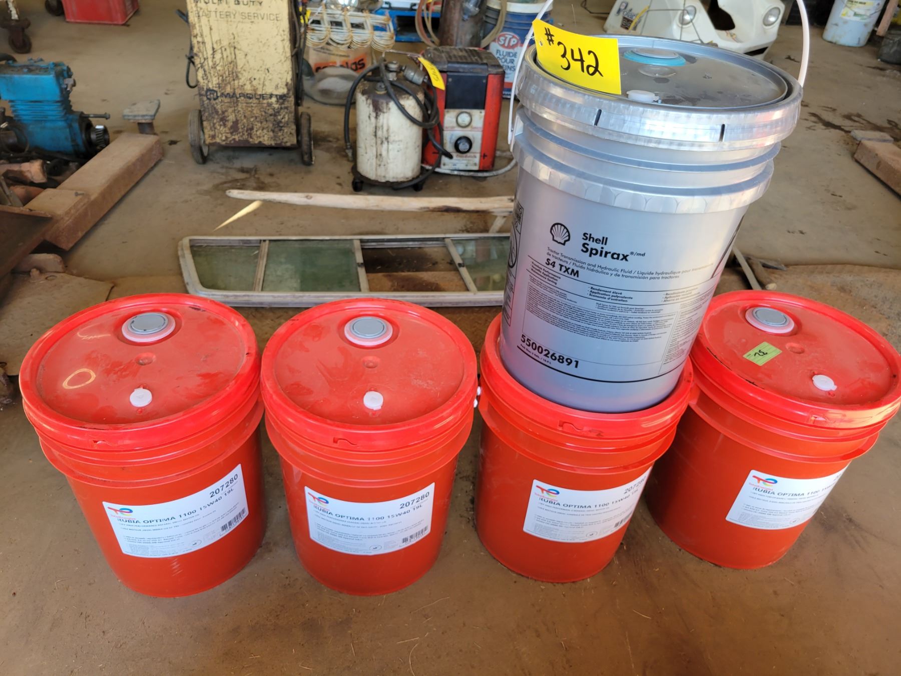 4- Pails of 15W40 oil, 1- Pail of trans fluid/hyd. etc.