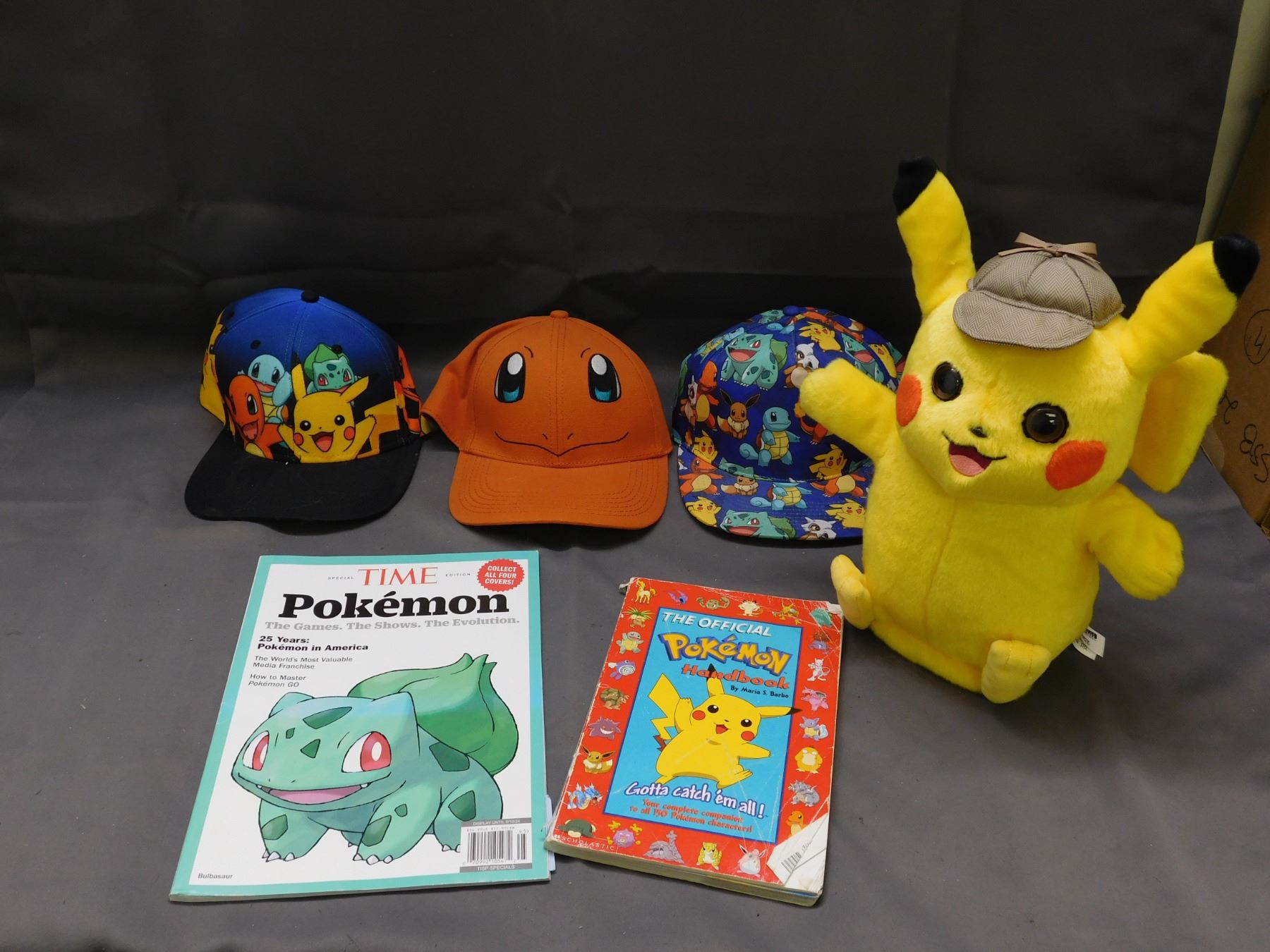 Lot of Pokemon Collectibles Official Handbook, Detective Pikachu Plush ...
