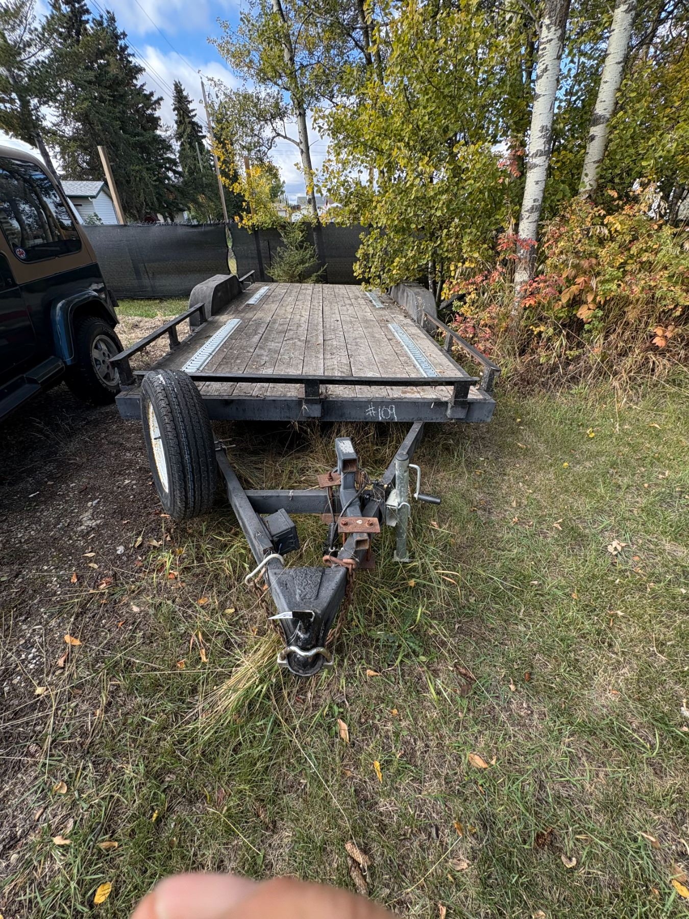 2011 16' Tandem flat deck trailer c/w ramps & spare. Approx 3000 lb ...