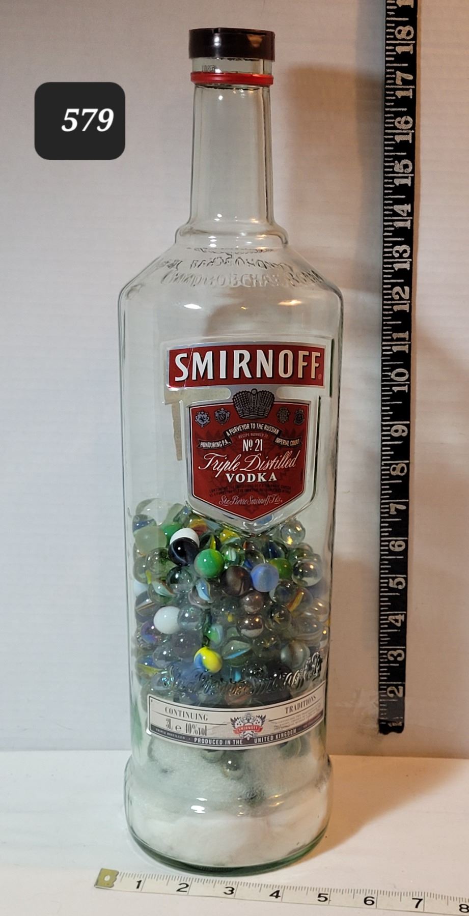 Large 3 litre Smirnoff vodka bottle filled with 350 marbles.