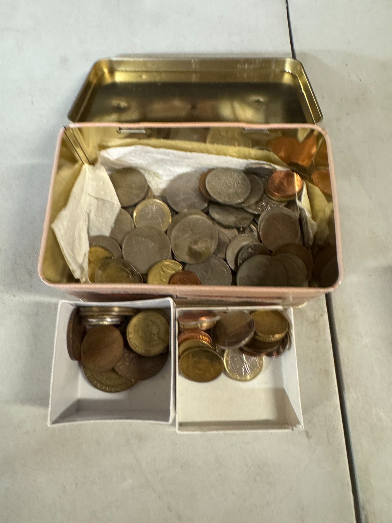 Tin of vintage foreign coins
