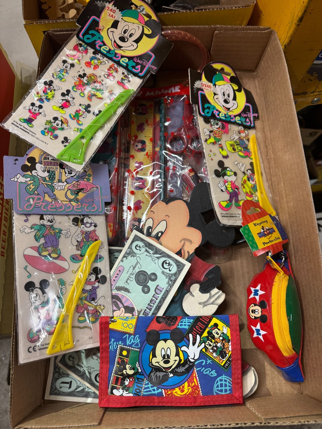 Mickey Mouse stickers, Disney dollars wallet, and other collectible items