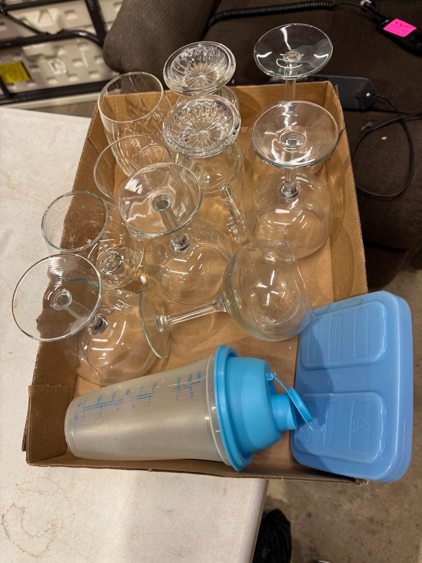 Assorted glasses, tupperware shaker, and ice pack